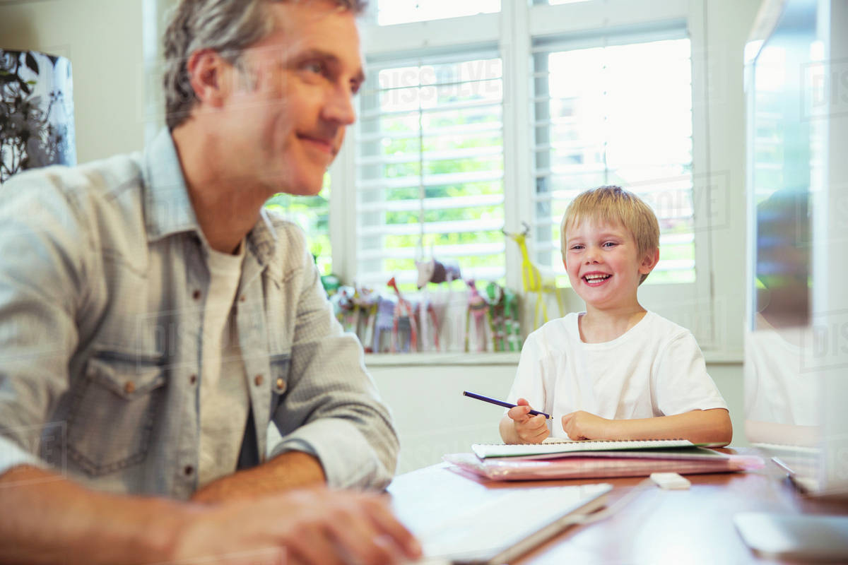 Father and son working in home office - Royalty-free Stock Photo | Dissolve