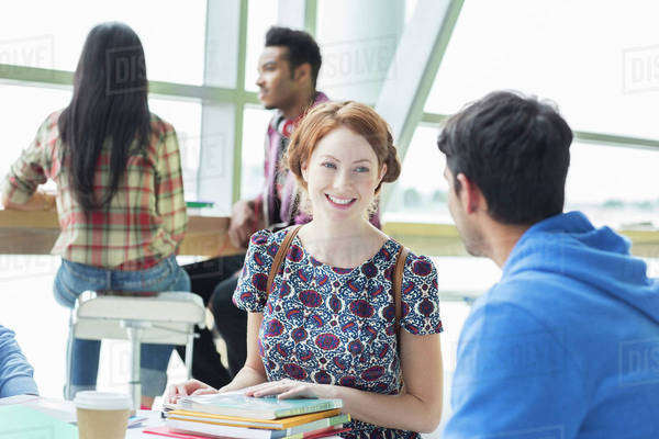 University students talking in cafe - Royalty-free Stock Photo | Dissolve