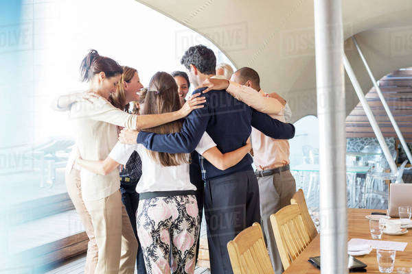 Business people talking in huddle - Stock Photo - Dissolve