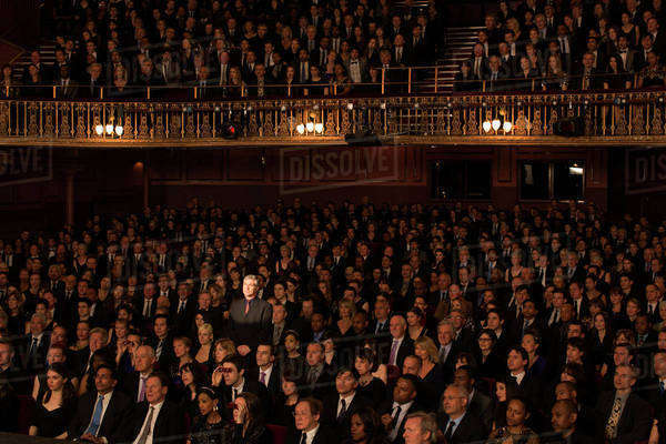 Spotlight on audience members in theater - Stock Photo - Dissolve