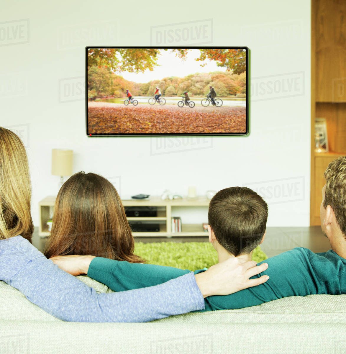 Family watching television in living room - Royalty-free Stock Photo ...