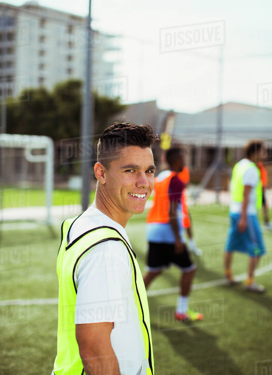 Soccer player smiling on field - Royalty-free Stock Photo | Dissolve