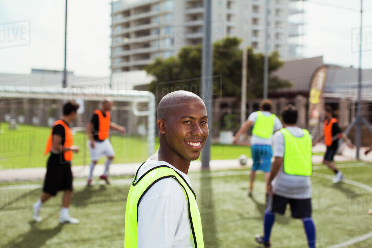Soccer player smiling on field - Royalty-free Stock Photo | Dissolve