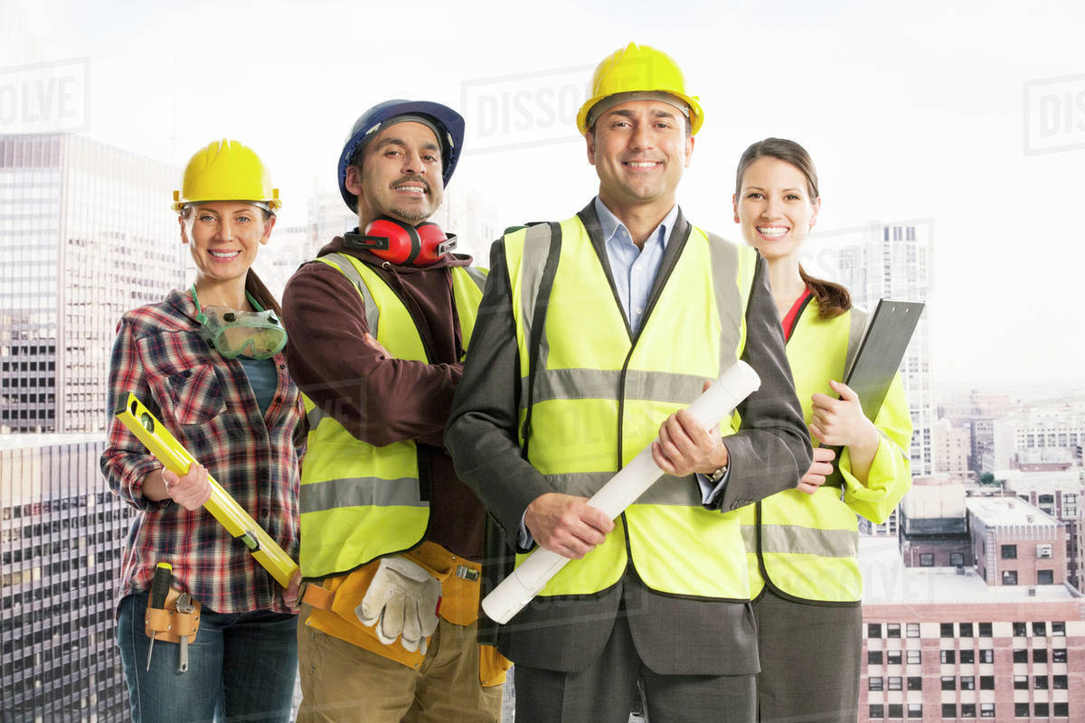 Portrait of confident construction workers in urban window - Stock ...
