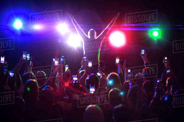Audience photographing musician on stage - Stock Photo - Dissolve