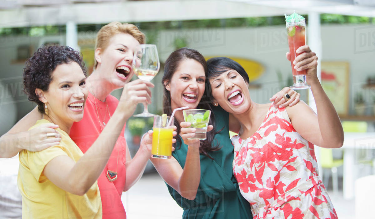 Women cheering together at party - Stock Photo - Dissolve