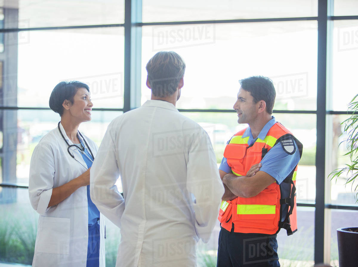 Doctors and paramedic talking in hospital - Stock Photo - Dissolve