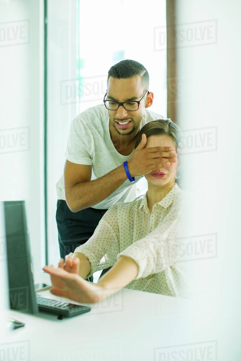 Man covering colleague’s eyes in office - Royalty-free Stock Photo ...