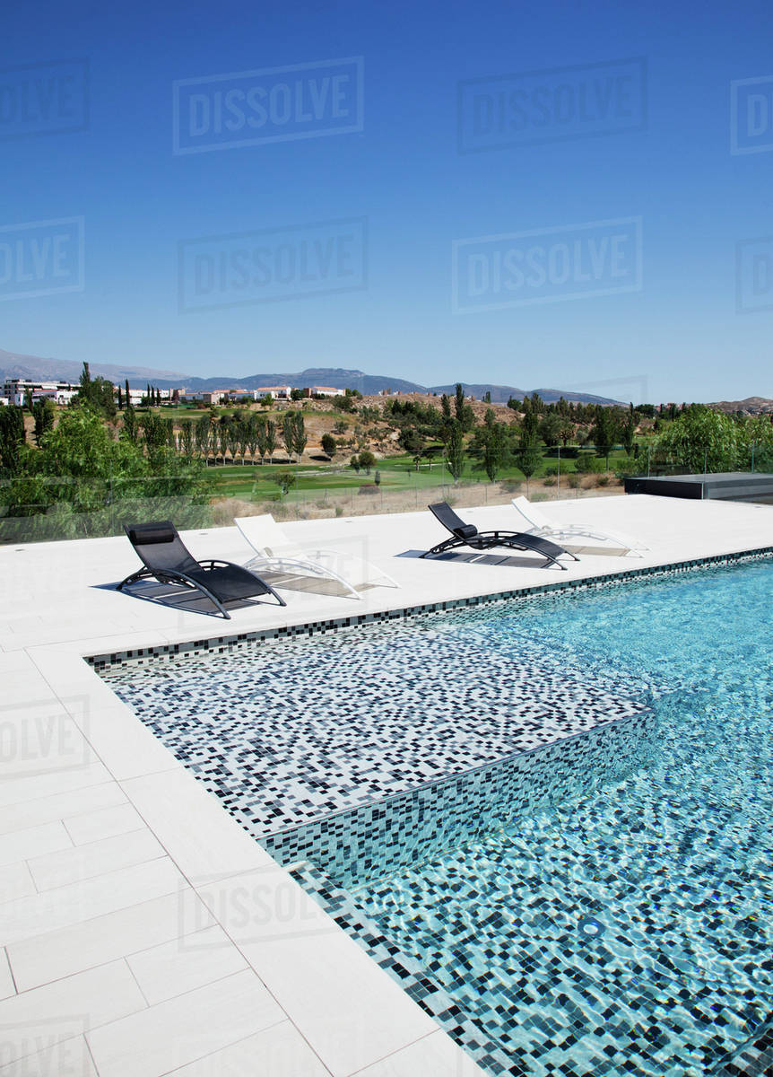 Lounge chairs and swimming pool - Royalty-free Stock Photo | Dissolve