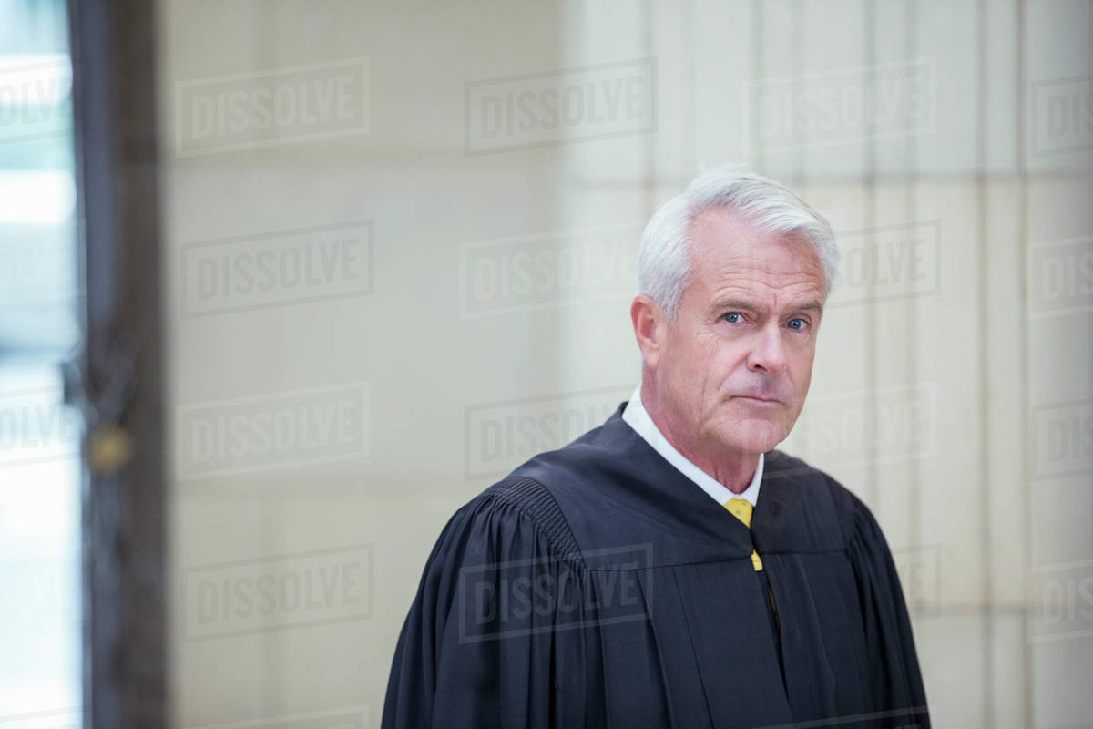 Judge standing in courthouse - Stock Photo - Dissolve