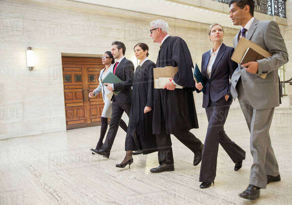 Judges and lawyers walking through courthouse together - Royalty-free ...