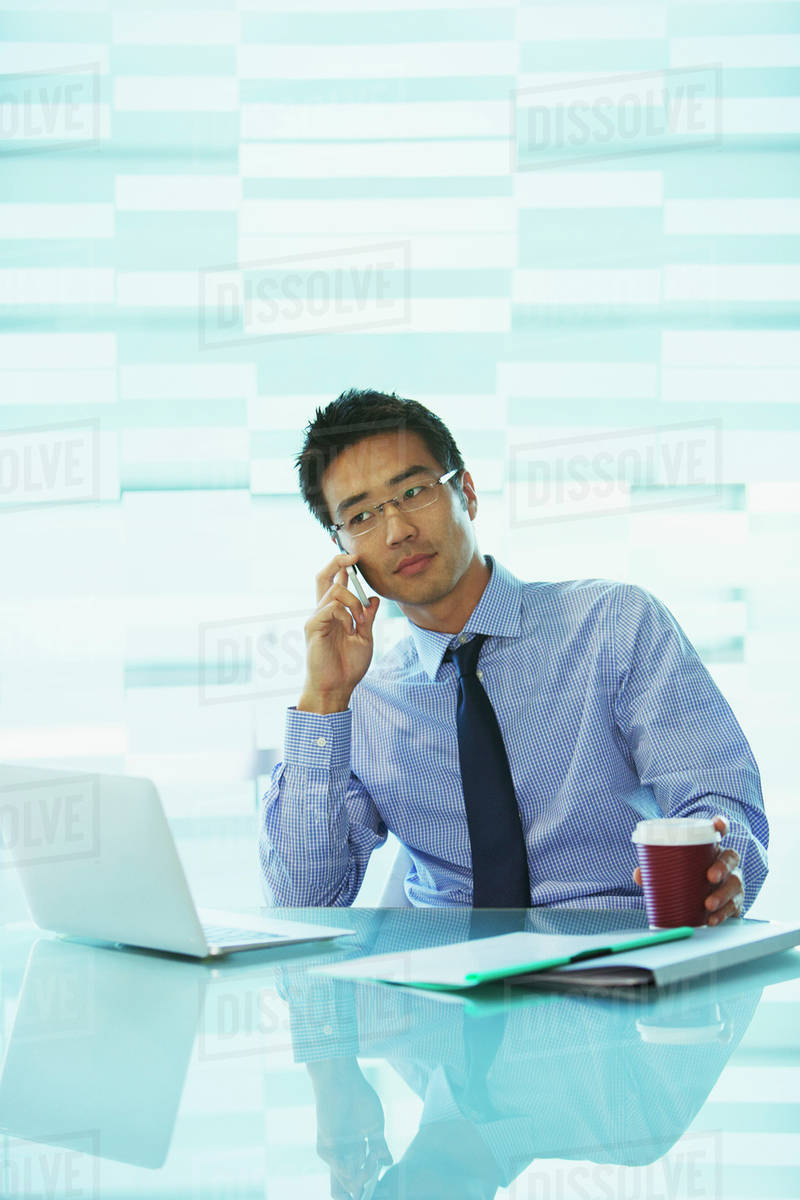 Businessman using laptop in office building cafe - Royalty-free Stock ...