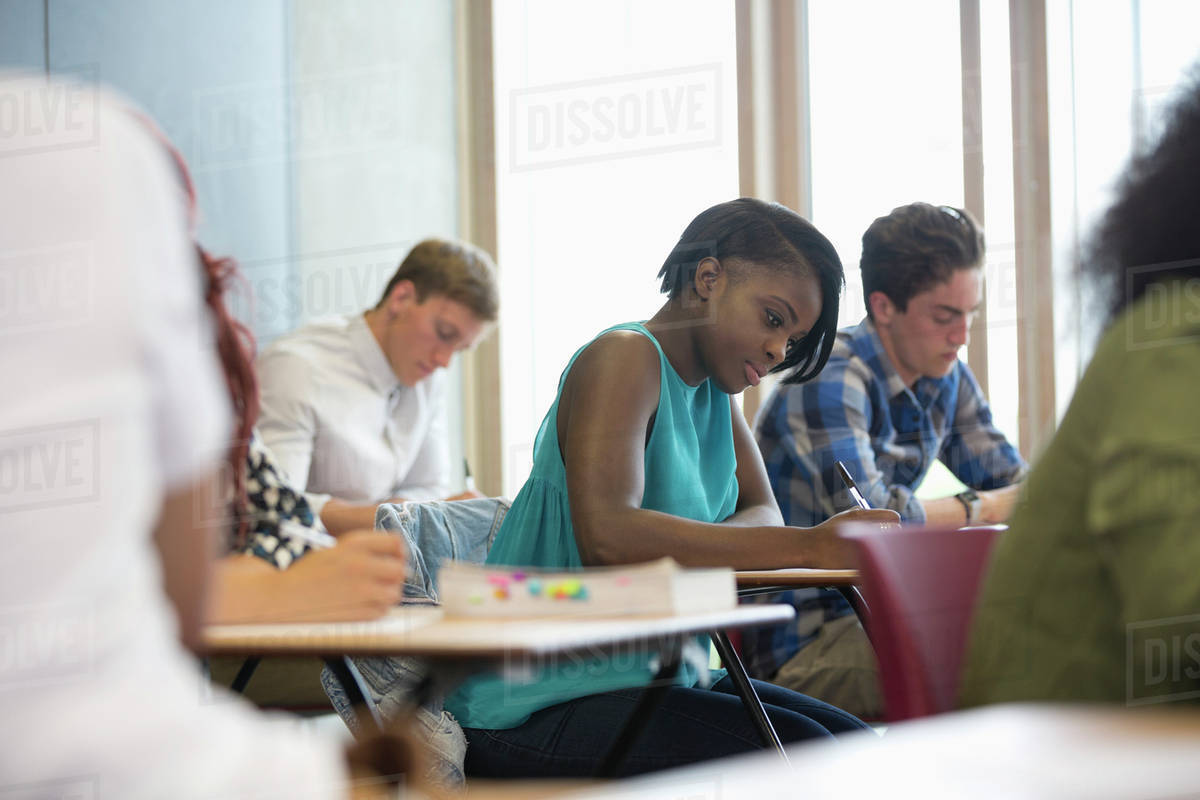View of students sitting at desks during test in classroom - Royalty ...