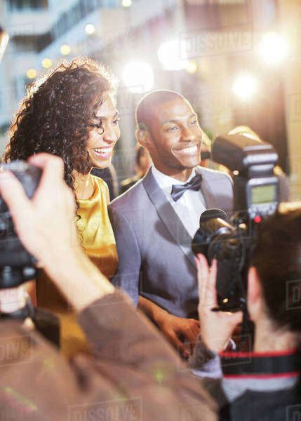 Celebrity couple being interviewed and photographed by paparazzi at ...