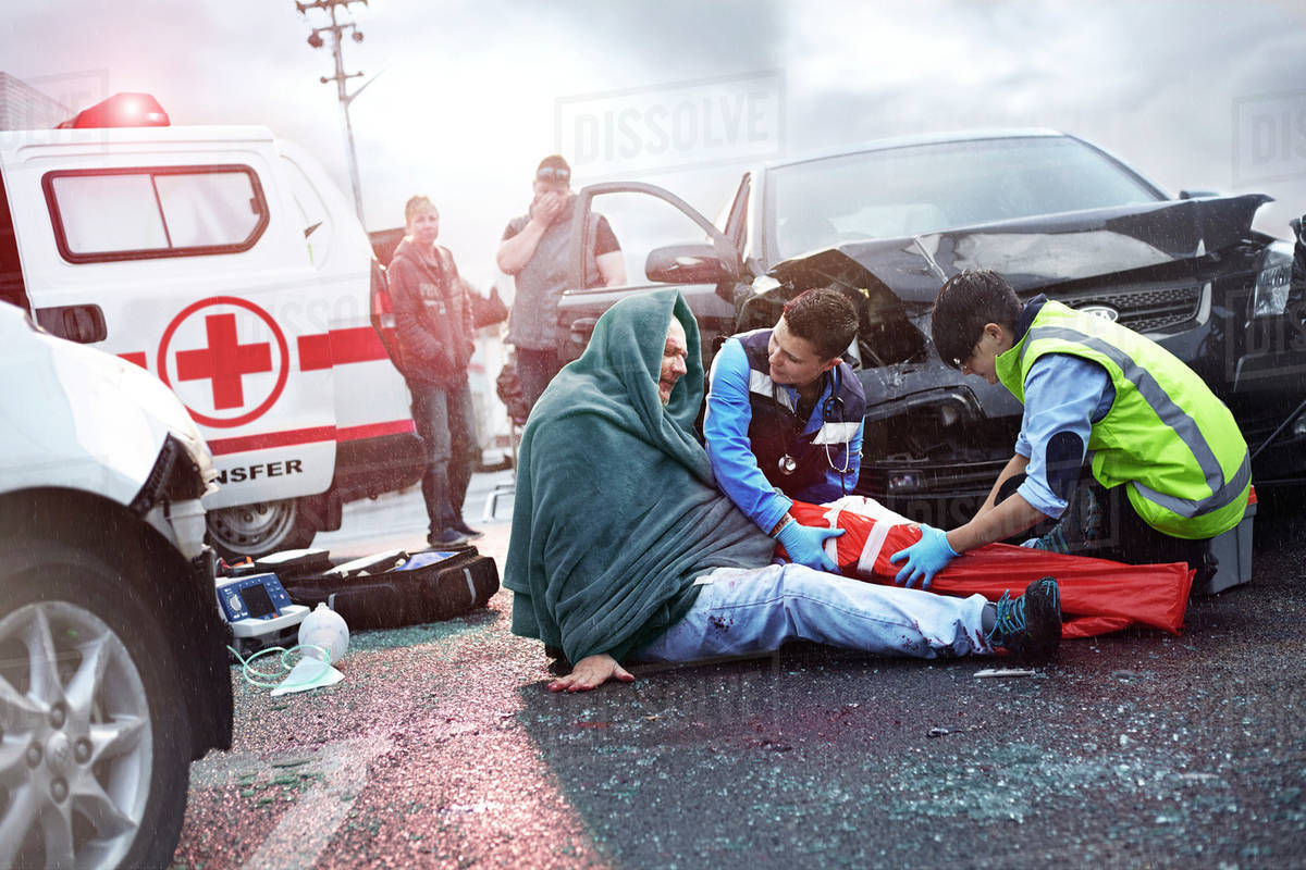 Rescue workers preparing vacuum leg splint on car accident victim in ...
