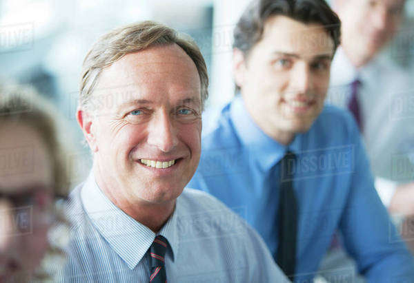 Businessmen smiling in meeting - Royalty-free Stock Photo | Dissolve