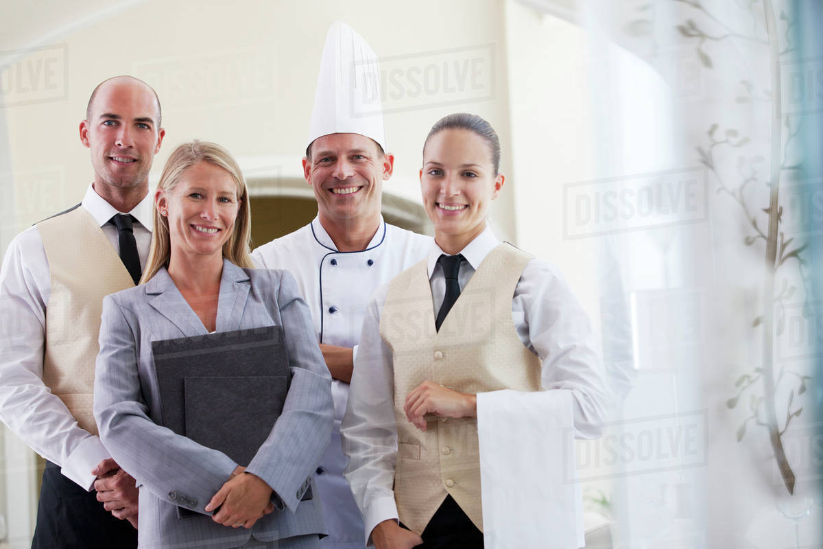 Staff smiling in restaurant - Royalty-free Stock Photo | Dissolve
