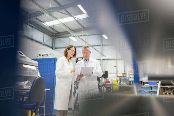 Engineers discussing paperwork in steel factory - Royalty-free Stock ...