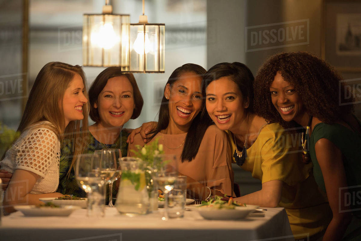 Portrait smiling women friends dining at restaurant table - Royalty ...