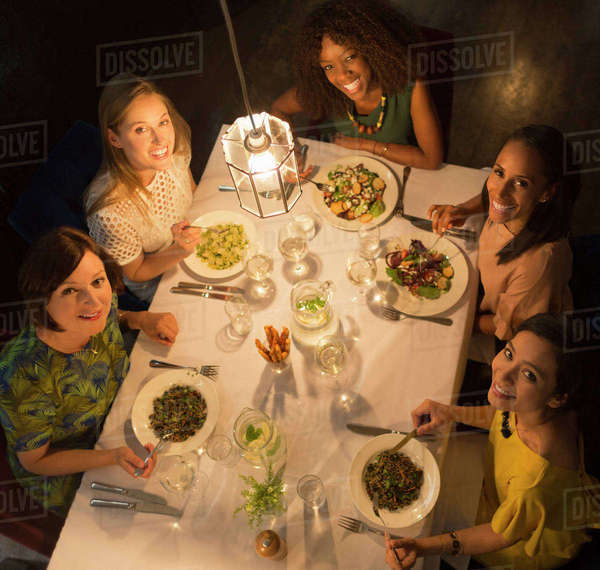 Portrait smiling women friends dining at restaurant table - Royalty ...