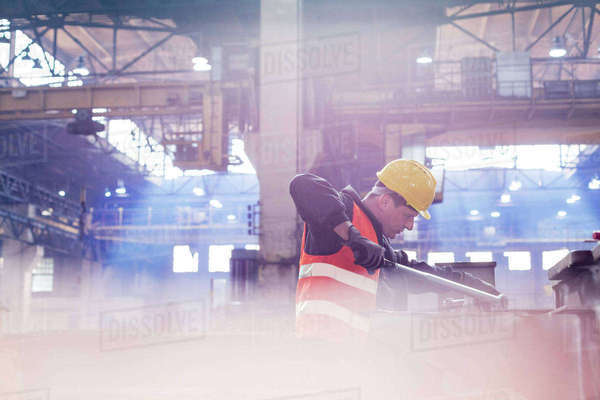 Steel worker working in factory - Royalty-free Stock Photo | Dissolve