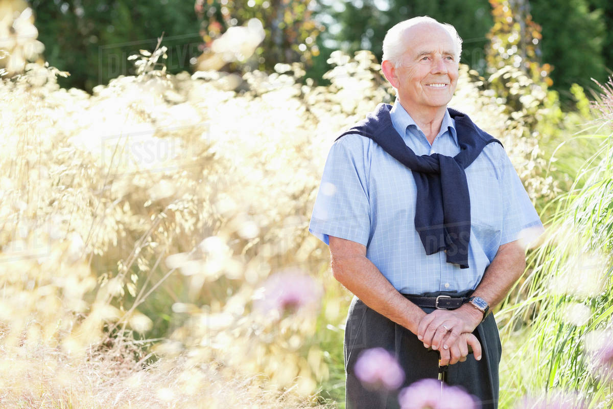 Older man smiling outdoors - Stock Photo - Dissolve