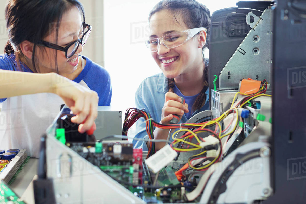 Smiling girl students assembling computer in classroom - Royalty-free ...