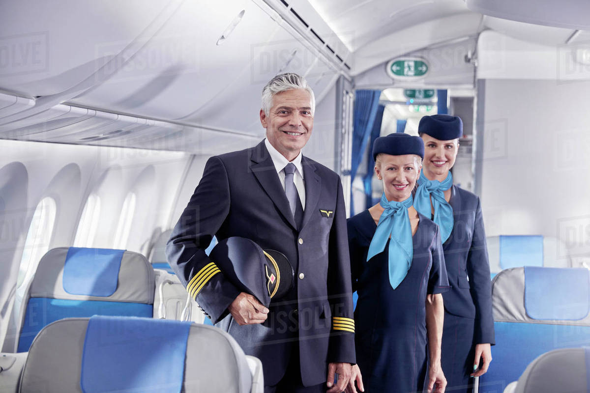 Portrait confident pilot and flight attendants on airplane - Royalty ...