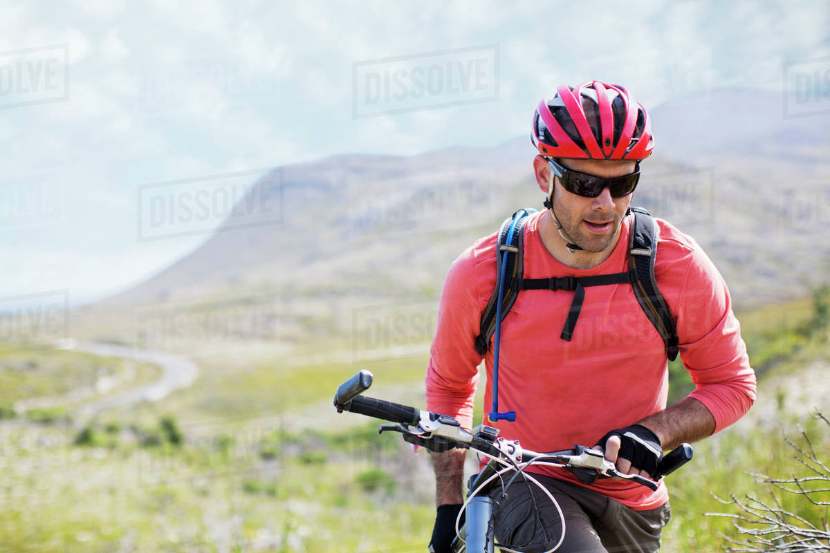 Man walking bicycle in rural landscape - Royalty-free Stock Photo ...