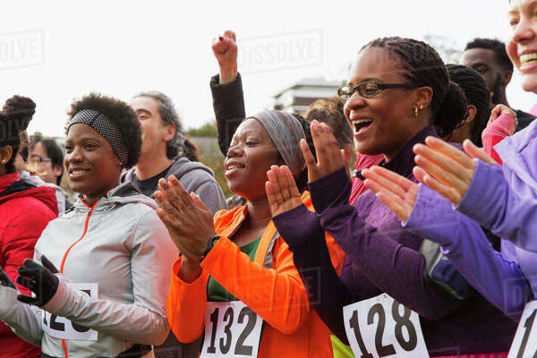 Marathon runners clapping, cheering - Stock Photo - Dissolve