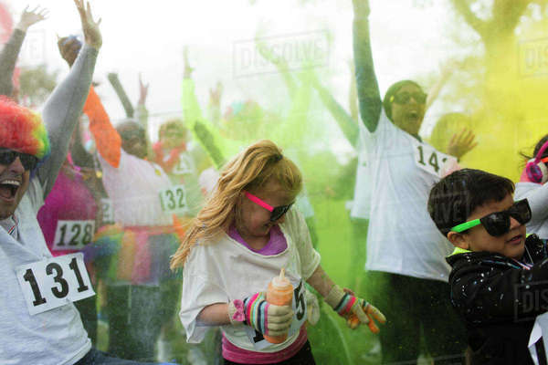 Playful crowd of runners throwing holi powder at charity run - Royalty ...