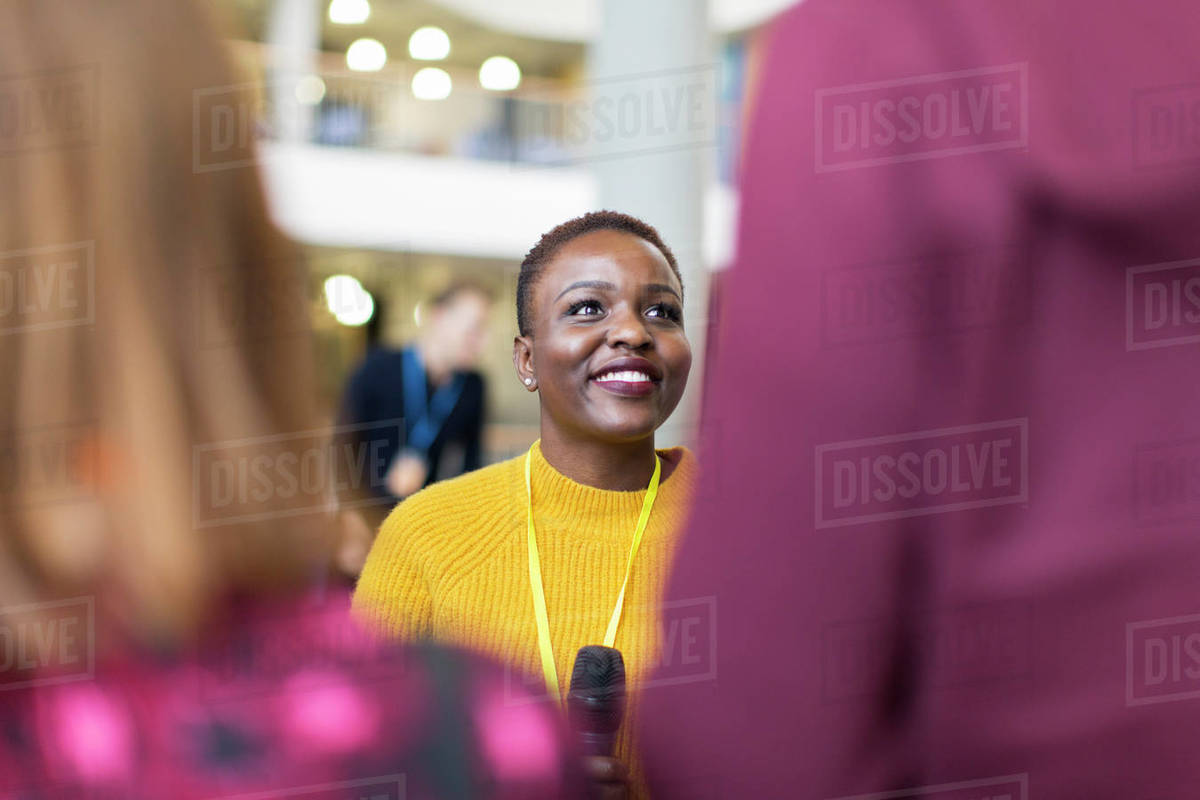 Smiling female speaker talking to audience - Royalty-free Stock Photo ...
