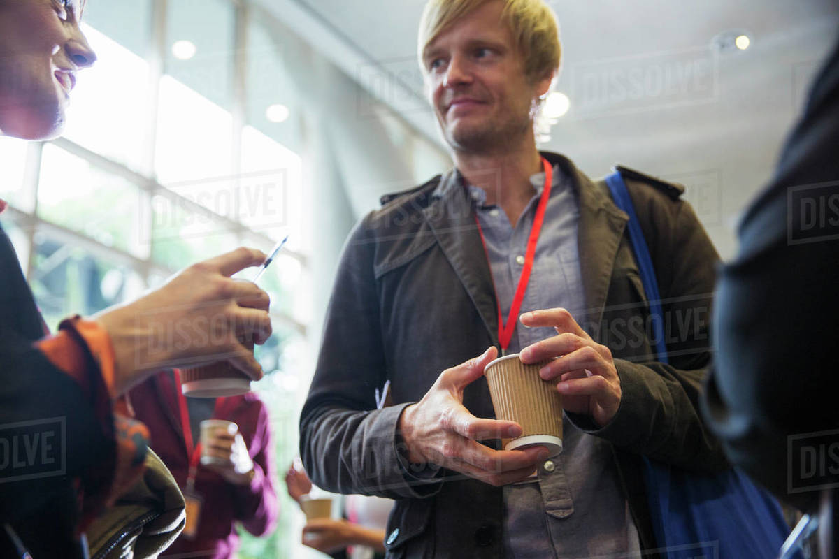 Business people with coffee networking, talking at conference - Royalty ...