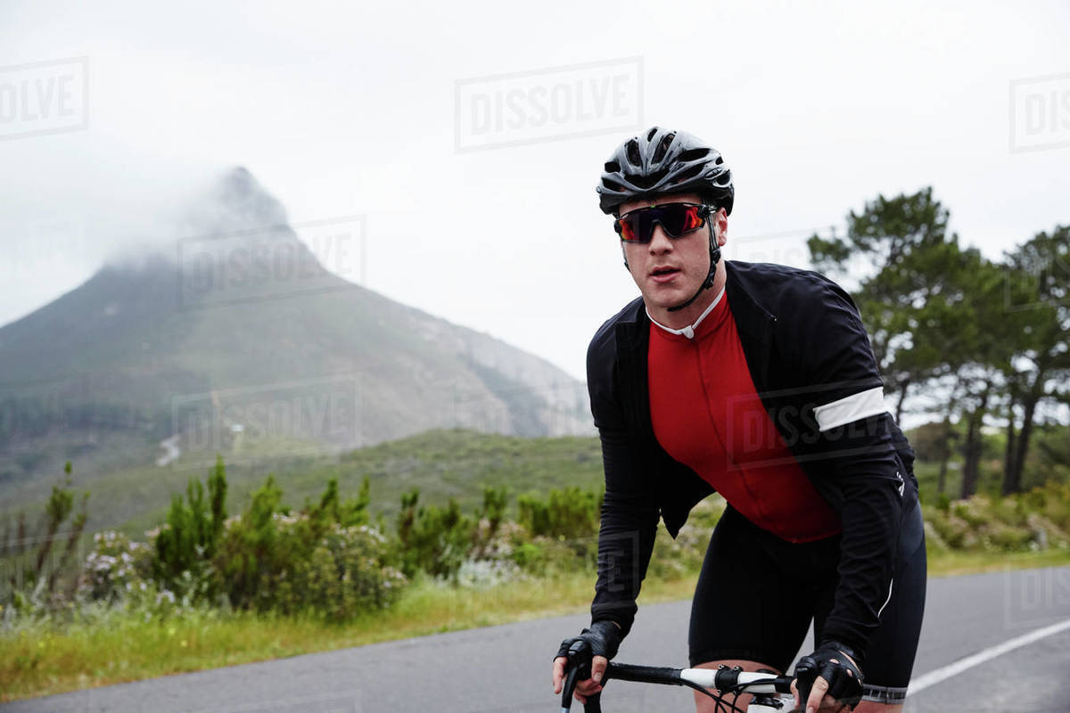Portrait confident, determined male cyclist cycling on road - Royalty ...