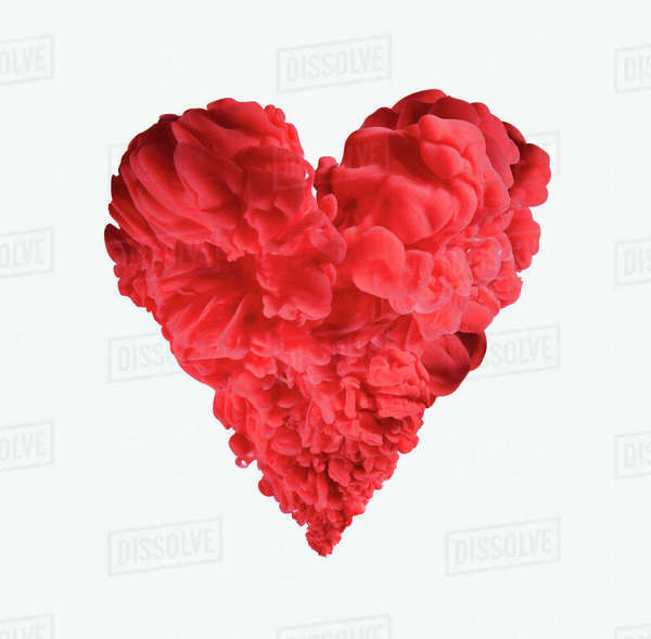 Red ink forming heart-shape on white background - Stock Photo - Dissolve