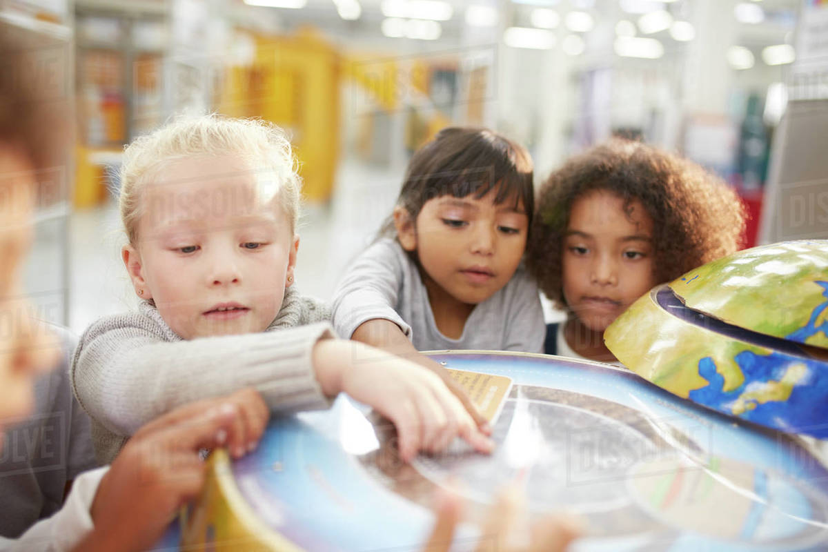 Curious kids at interactive globe exhibit in science center - Royalty ...