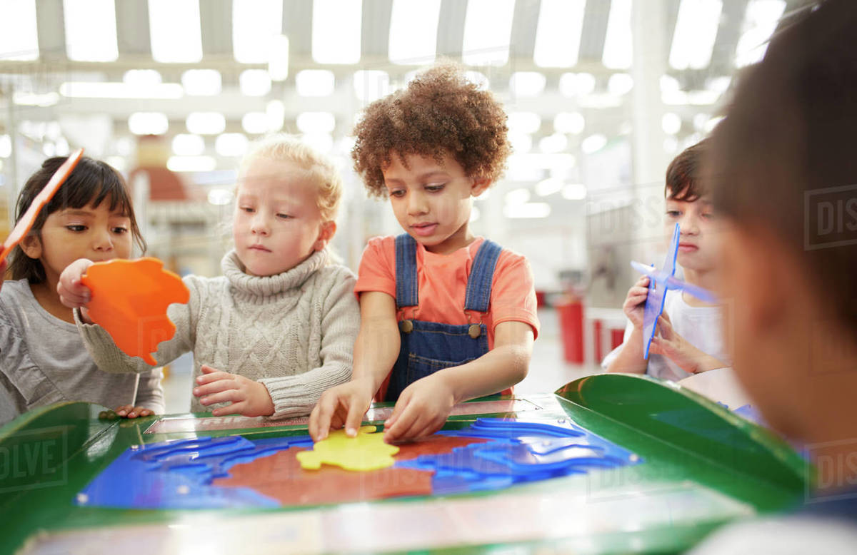 Kids playing at interactive exhibit in science center - Royalty-free ...