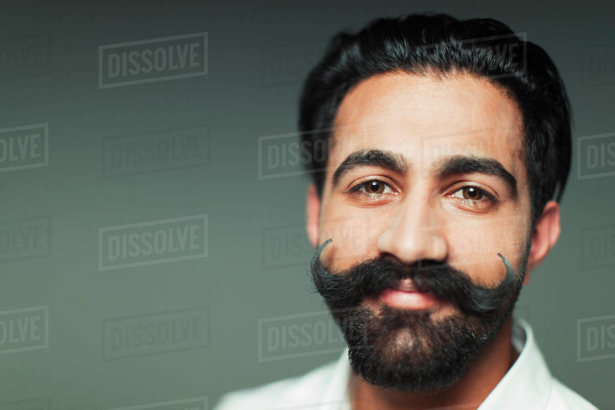 Portrait smiling, confident young man with handlebar handlebar mustache ...