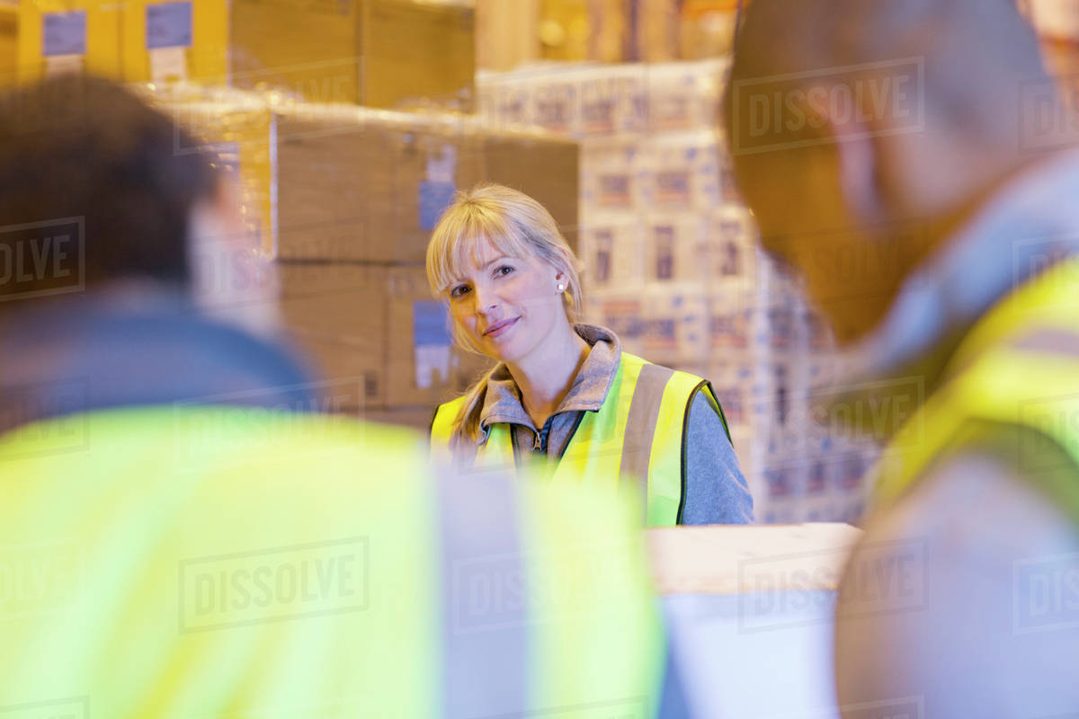 Workers talking in warehouse - Royalty-free Stock Photo | Dissolve
