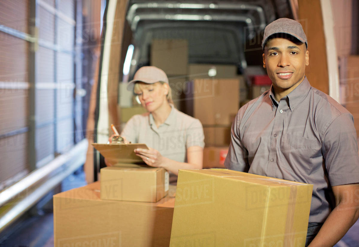 Delivery people loading boxes into van - Royalty-free Stock Photo ...