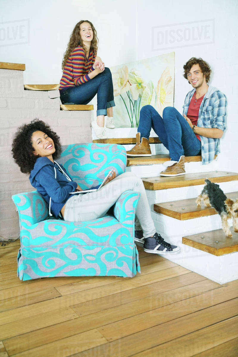 Friends relaxing together on steps - Royalty-free Stock Photo | Dissolve