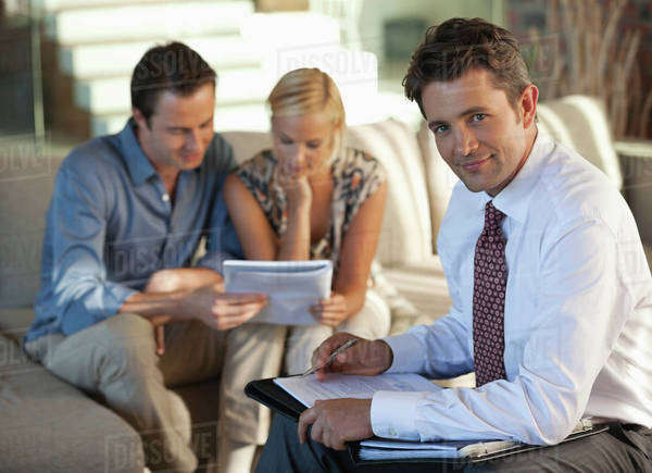 Financial advisor with couple on sofa - Royalty-free Stock Photo | Dissolve