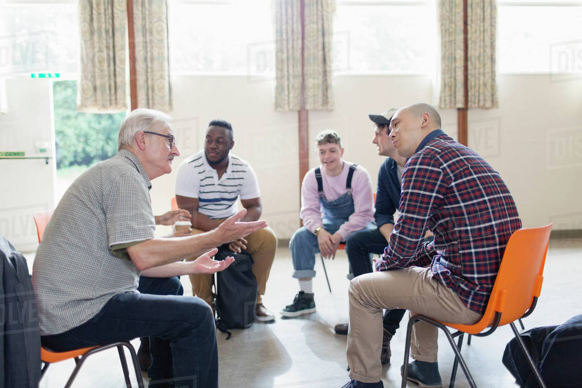 Men talking and listening in group therapy - Royalty-free Stock Photo ...
