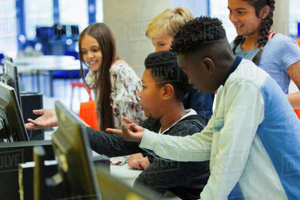 Junior high students using computer in library - Stock Photo - Dissolve