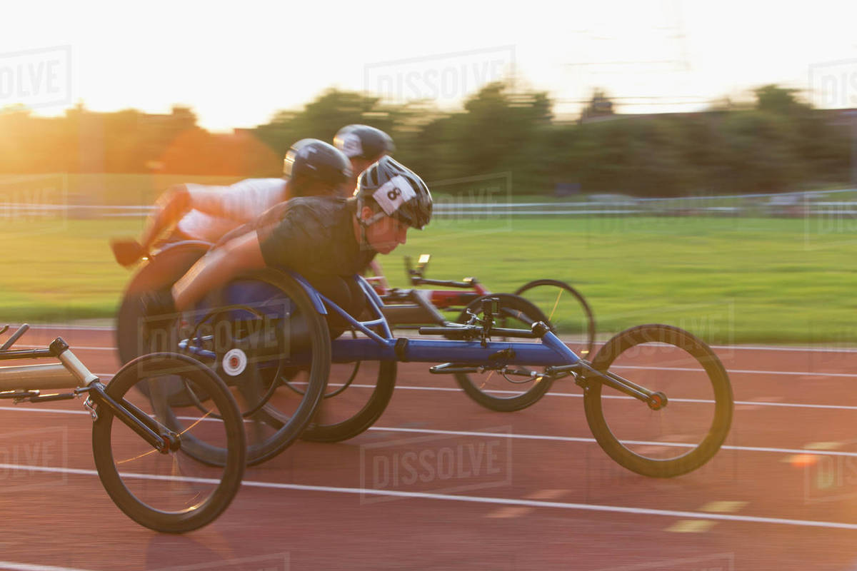 Paraplegic athletes speeding along sports track in wheelchair race ...