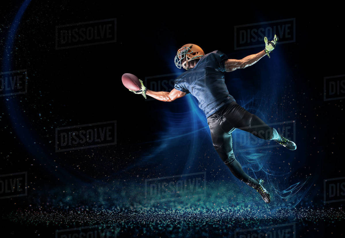Football player reaching to catch football - Royalty-free Stock Photo ...