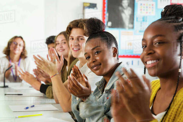 High school students clapping in debate class - Stock Photo - Dissolve