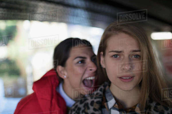 Angry young woman yelling at friend - Royalty-free Stock Photo | Dissolve