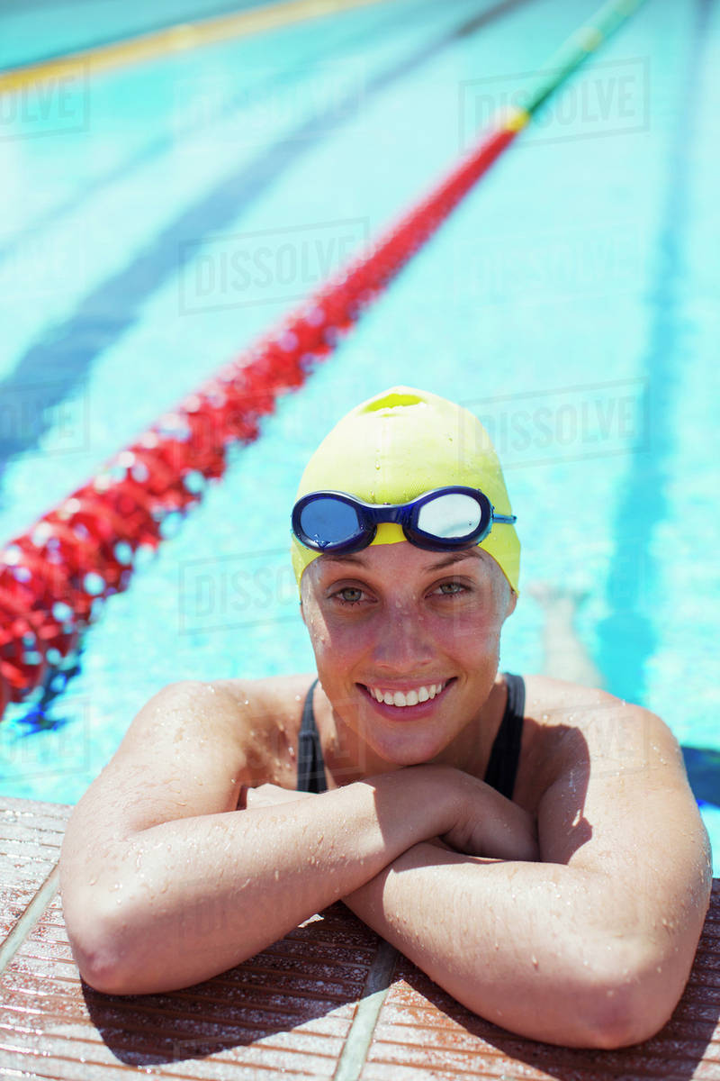 Portrait of smiling swimmer leaning at edge of pool - Royalty-free ...