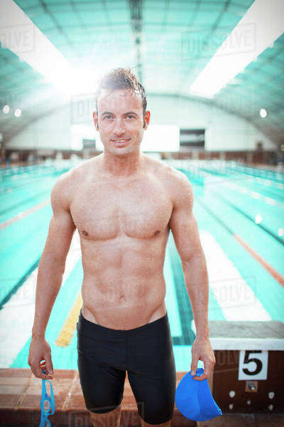 Swimmer standing at poolside - Royalty-free Stock Photo | Dissolve